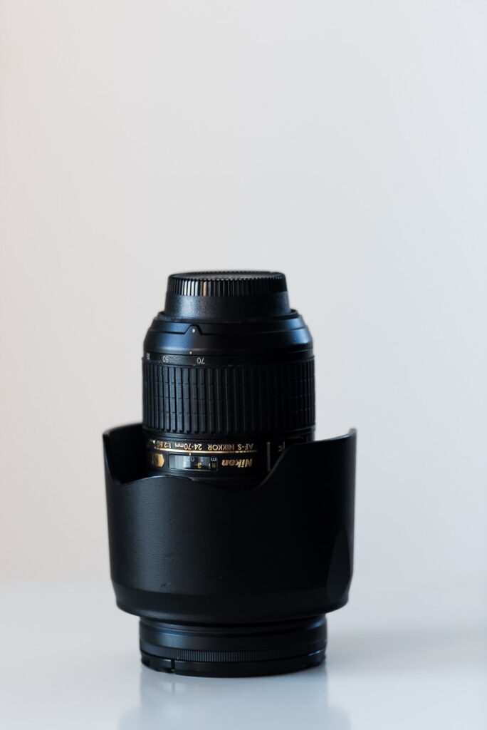 What is the purpose of a lens hood in portrait photography?